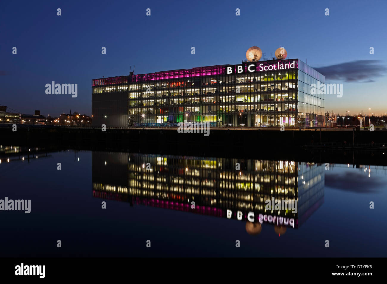 The illuminated BBC Scotland Headquarters on Pacific Quay reflected in ...