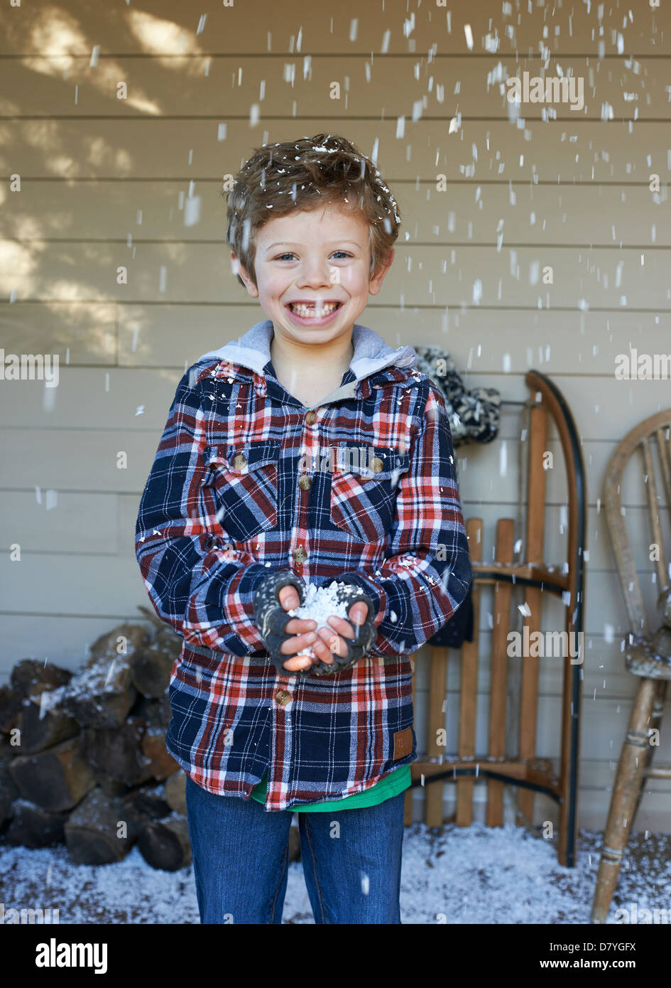 Smiling boy playing in snow Stock Photo - Alamy