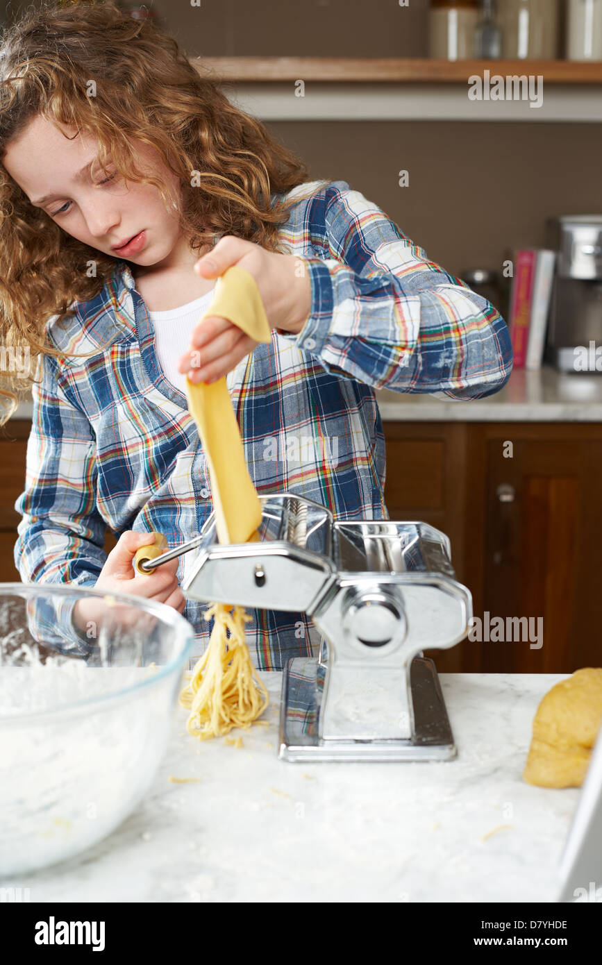 Girl rolling pasta dough in kitchen Stock Photo - Alamy