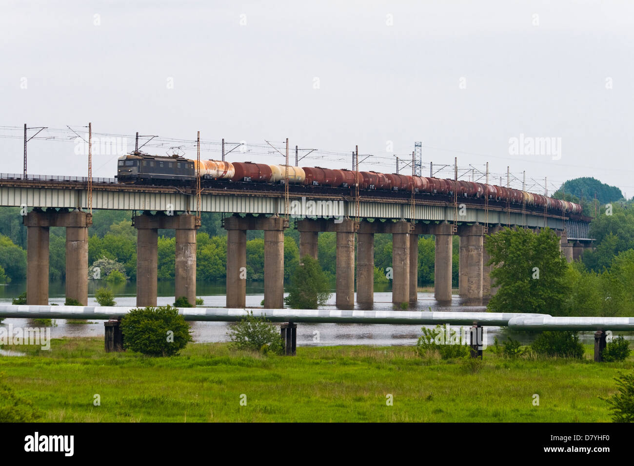 Fuel freight train passing the steel bridge over the river Stock Photo ...
