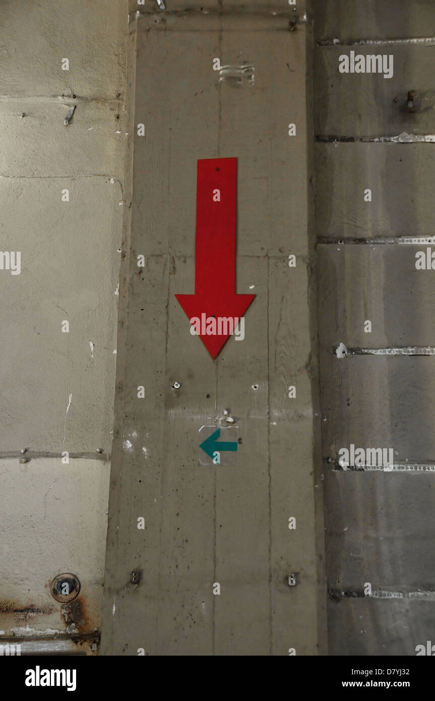 Concrete factory wall and arrow signs. Industrial background Stock ...