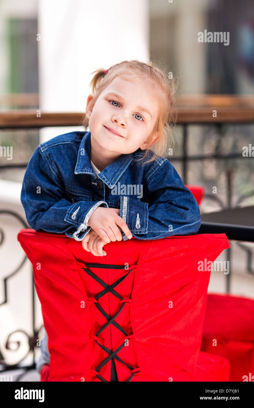 Cute little child sitting in a cafe in shopping center Stock Photo - Alamy