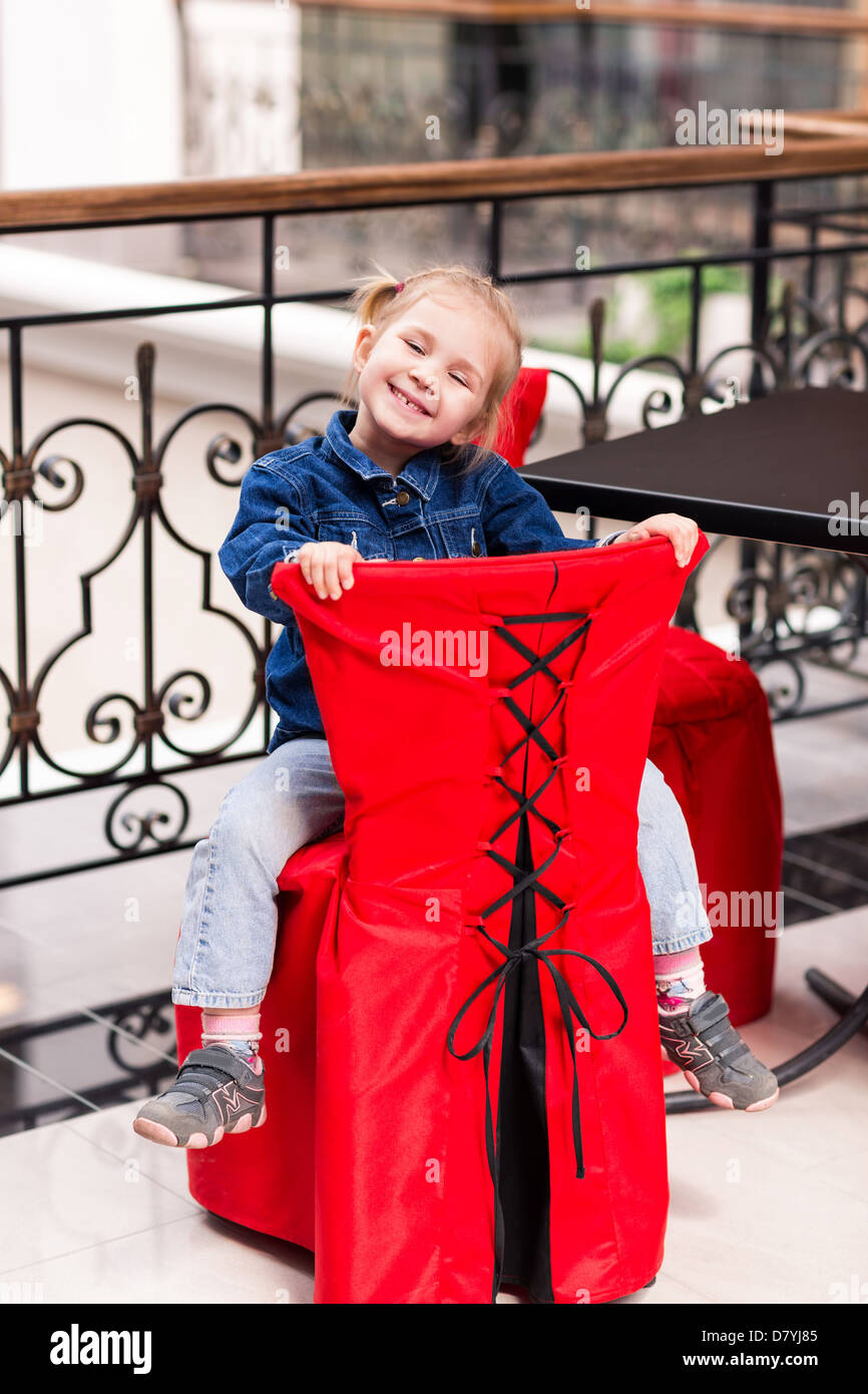 Cute little child sitting in a cafe in shopping center Stock Photo - Alamy