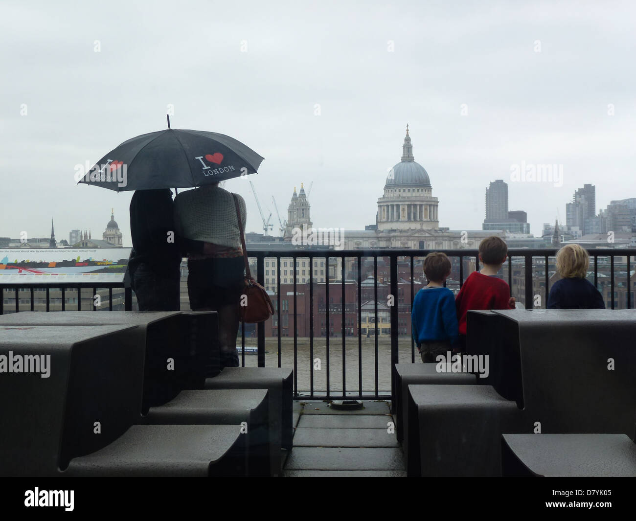 Children and a Couple with I love London umbrella overlooking London's ...