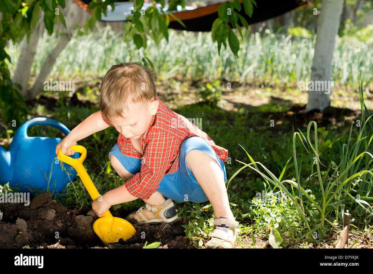 Child scooping soil High Resolution Stock Photography and Images - Alamy