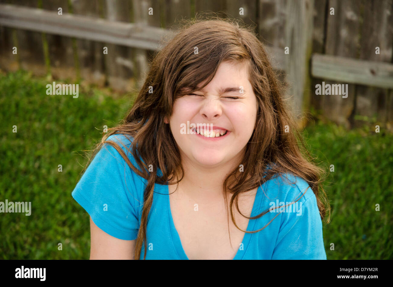 Teen Girl Grinning with Eyes Closed Stock Photo - Alamy