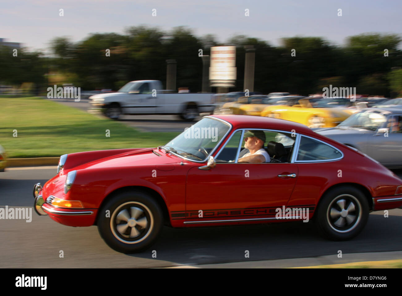 A classic Porsche 911 drives by at the Porsche Parade 2008 in downtown ...