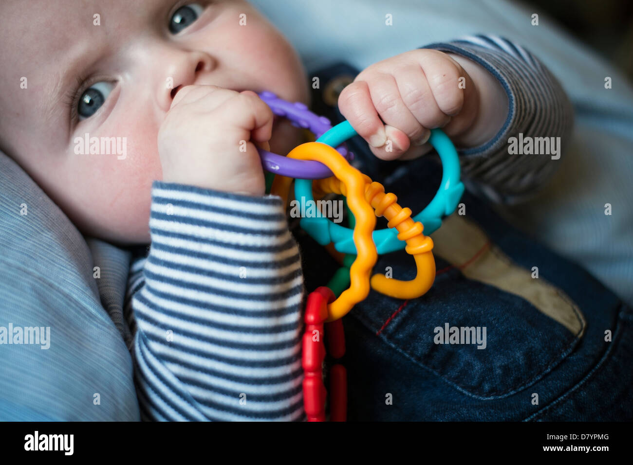 A baby boy playing with teething rings Stock Photo - Alamy