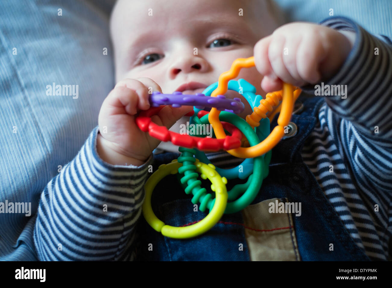 A baby boy playing with teething rings Stock Photo - Alamy