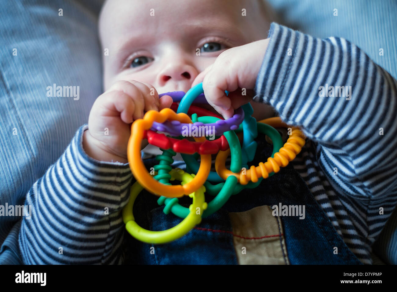 A baby boy playing with teething rings Stock Photo - Alamy