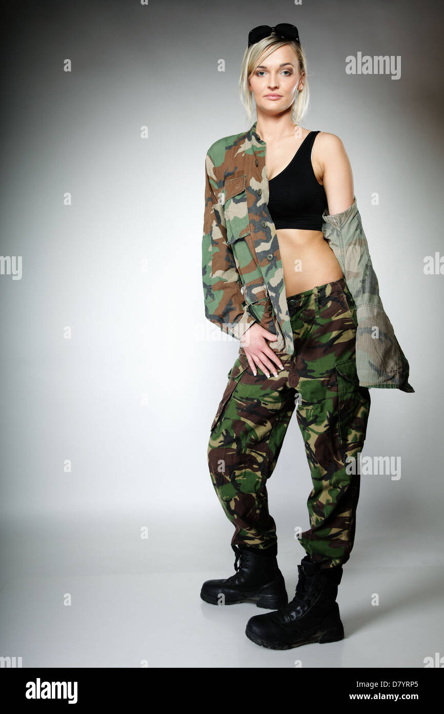 Full length woman in military clothes army girl on gray background ...