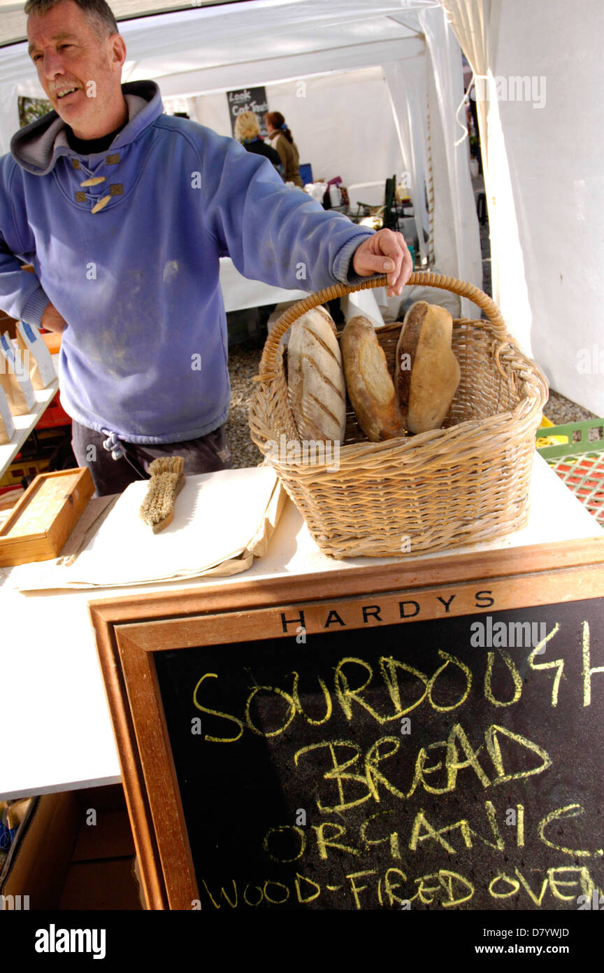Baker selling sourdough bread at farmers market Stock Photo - Alamy