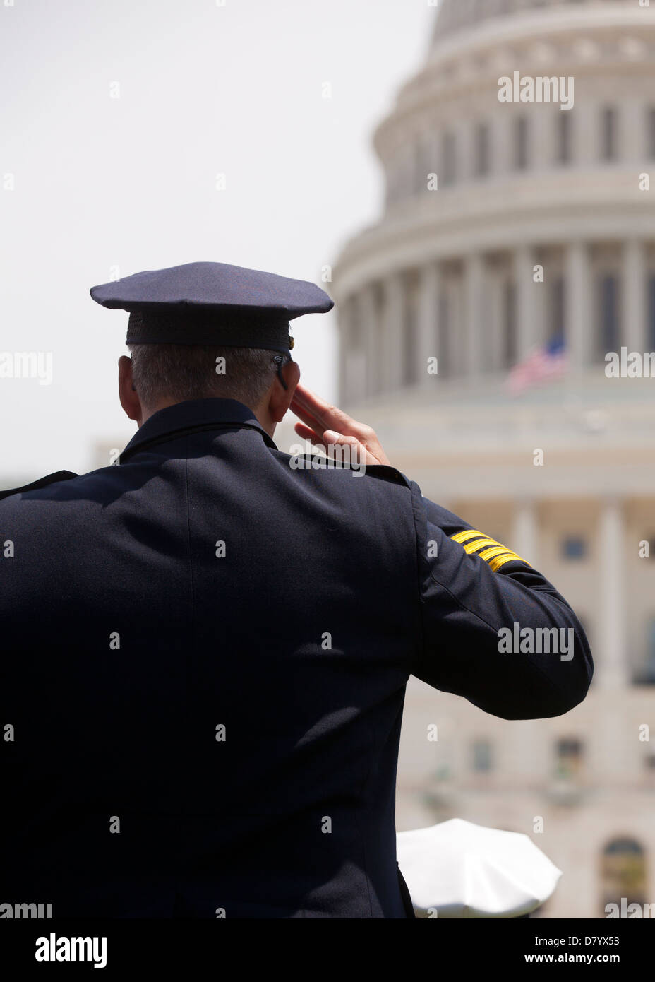 Policeman saluting in front of the US Capitol building - Washington, DC ...