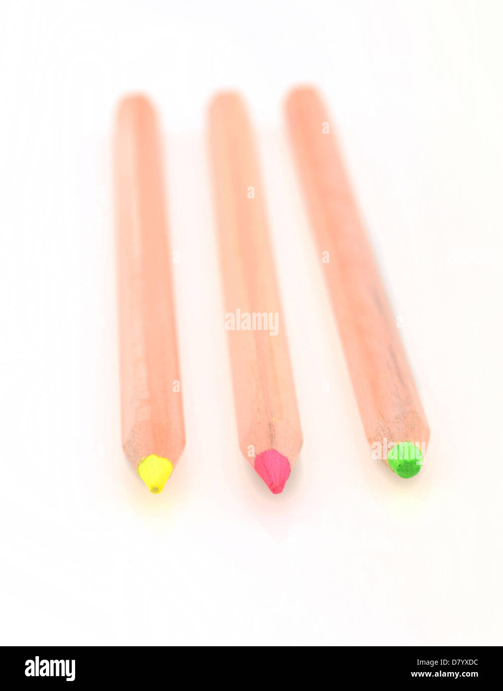 Three bright colored pencils on white background Stock Photo - Alamy