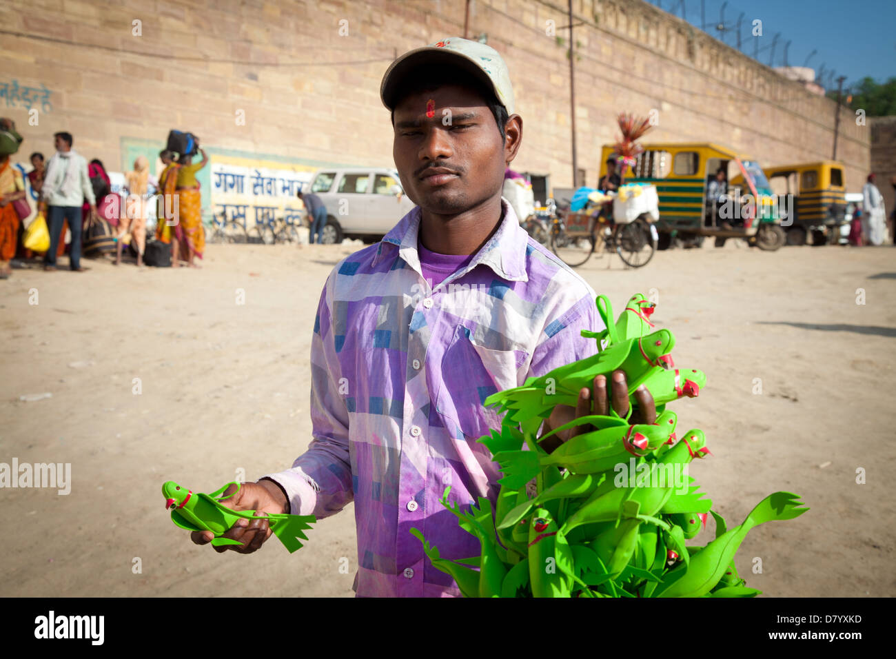 Stuffed parakeet seller at the meeting of rivers Ganga and Yamuna near ...