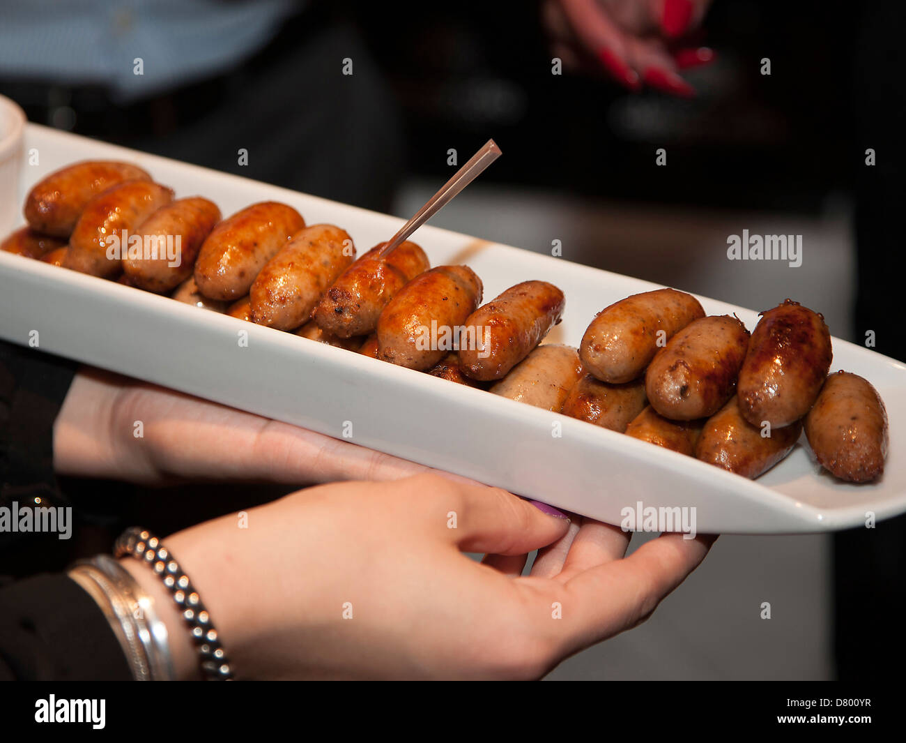 Tray of cocktail sausages at a party Stock Photo - Alamy