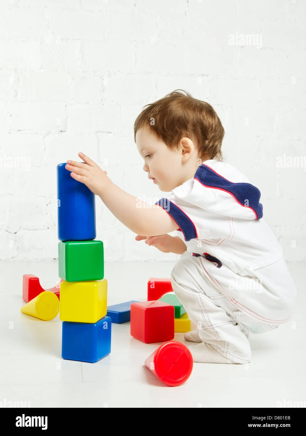 beautiful little boy playing with colorful cubes Stock Photo - Alamy