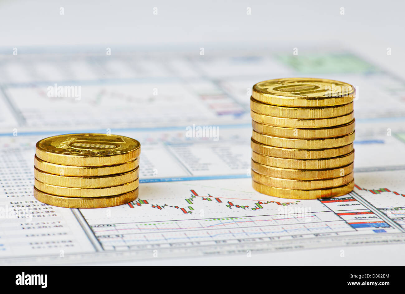 Financial chart and columns of golden coins. Successful trading ...