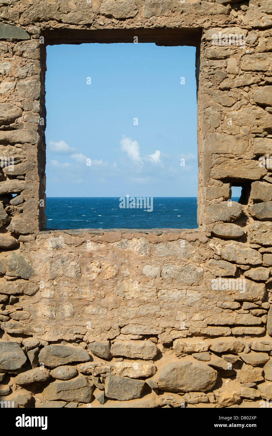 Ocean viewed through window of stone wall Stock Photo - Alamy