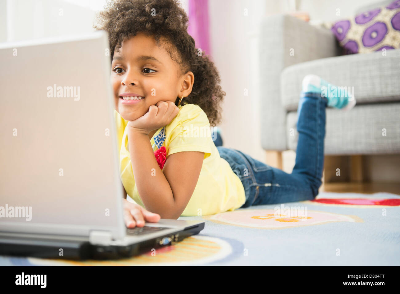 African American girl using laptop on floor Stock Photo - Alamy