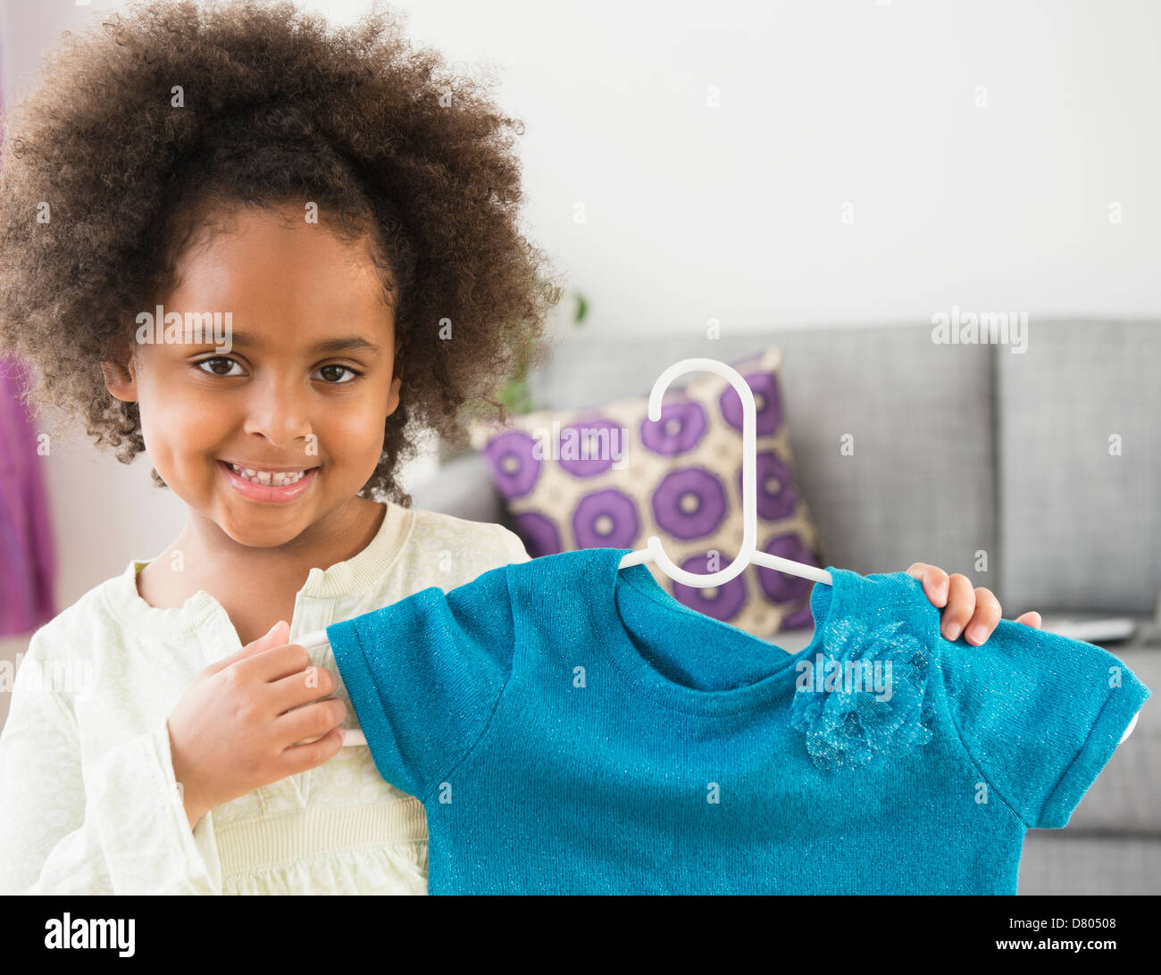 African American girl showing new shirt Stock Photo - Alamy