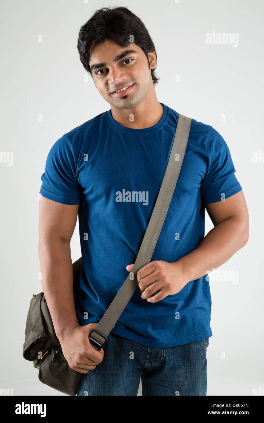 Male university student carrying a bag and smiling Stock Photo - Alamy Male university student carrying a bag and smiling Stock Photo - Alamy