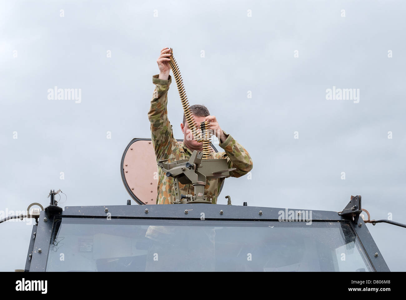 A soldier loading a weapon on a Royal Australian Air Force Bushmaster ...