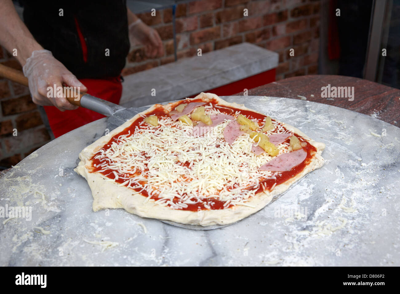 man making pizza carrying on a peel about to place in the oven Stock ...