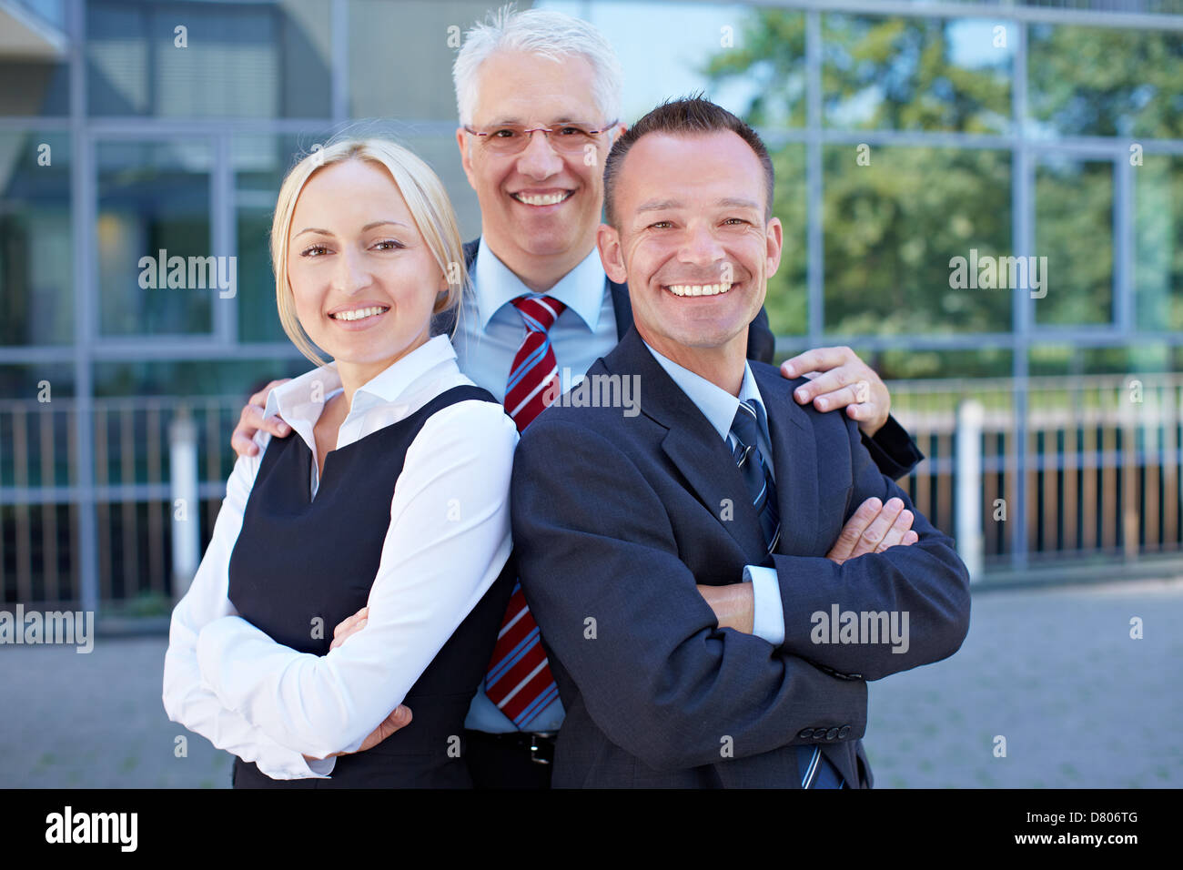 Team of three successful business people smiling together Stock Photo ...