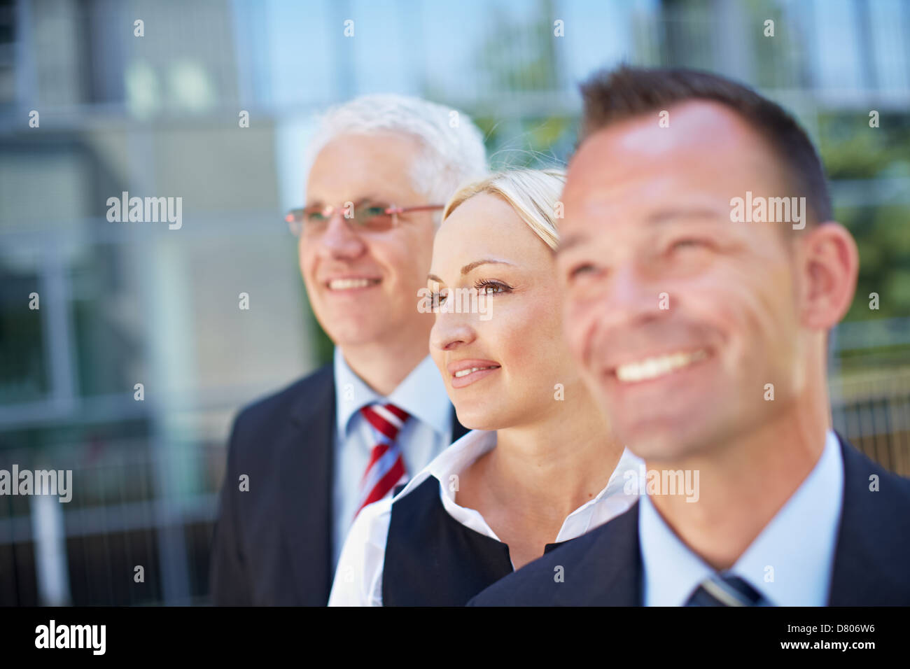 Visionary business team in a row looking into the same direction ...