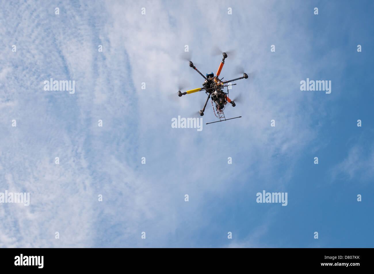 A drone with a camera hovers overhead in the sky Stock Photo - Alamy