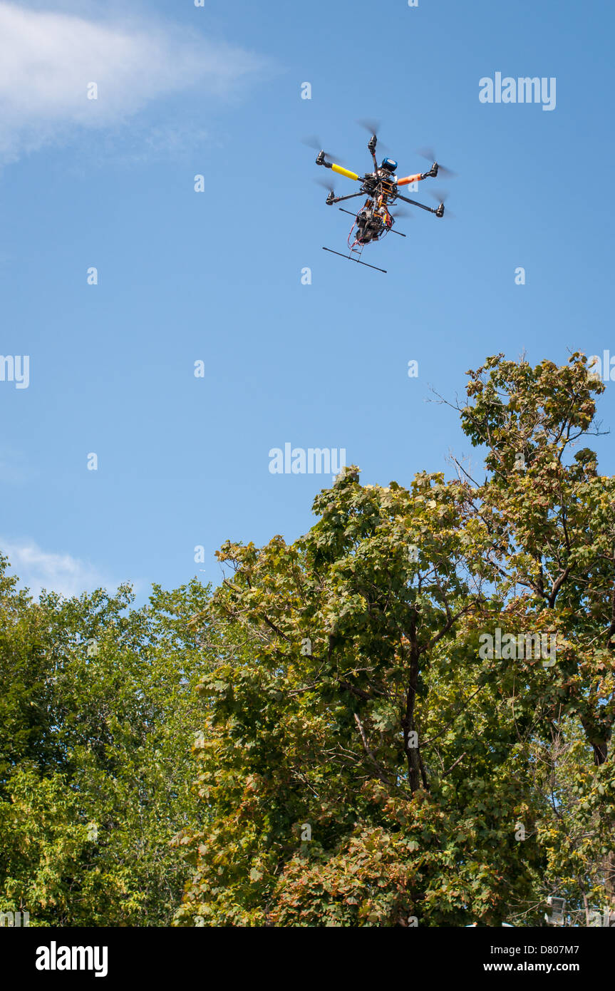 A drone with a camera hovers over a park in Brooklyn Stock Photo - Alamy
