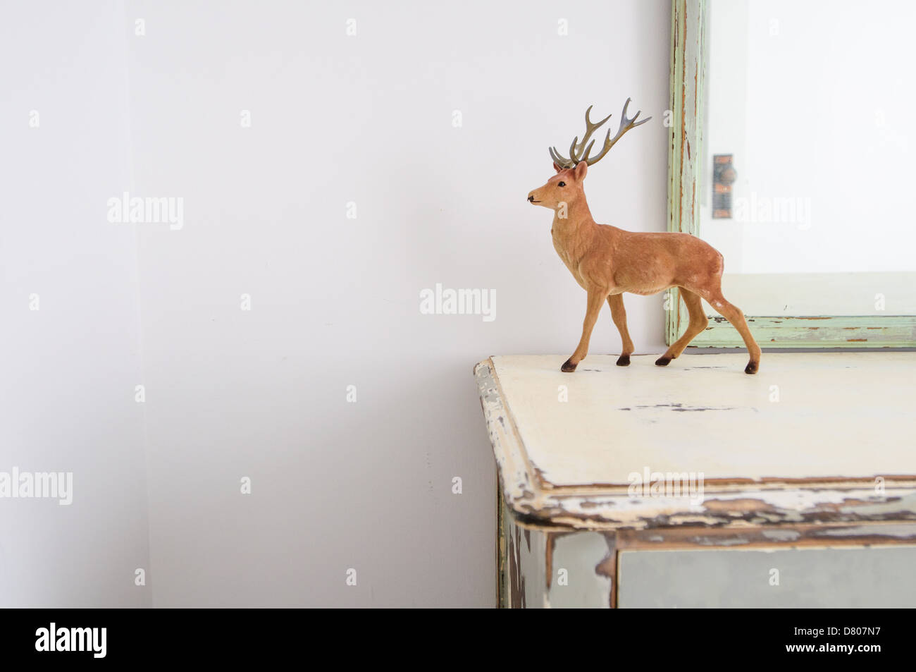 A small fake deer on a weathered dresser Stock Photo - Alamy
