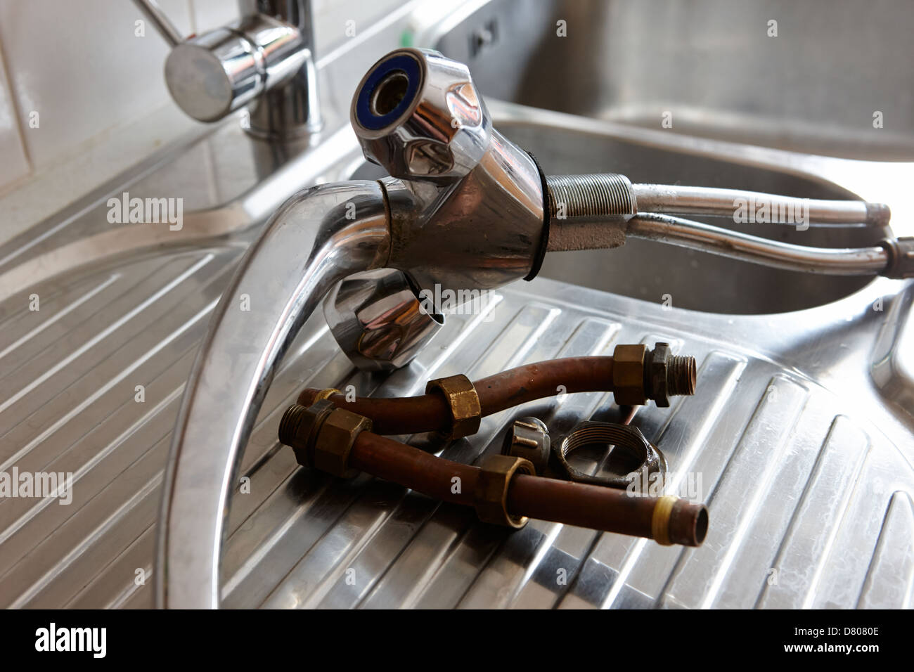 replacing a household kitchen tap Stock Photo - Alamy