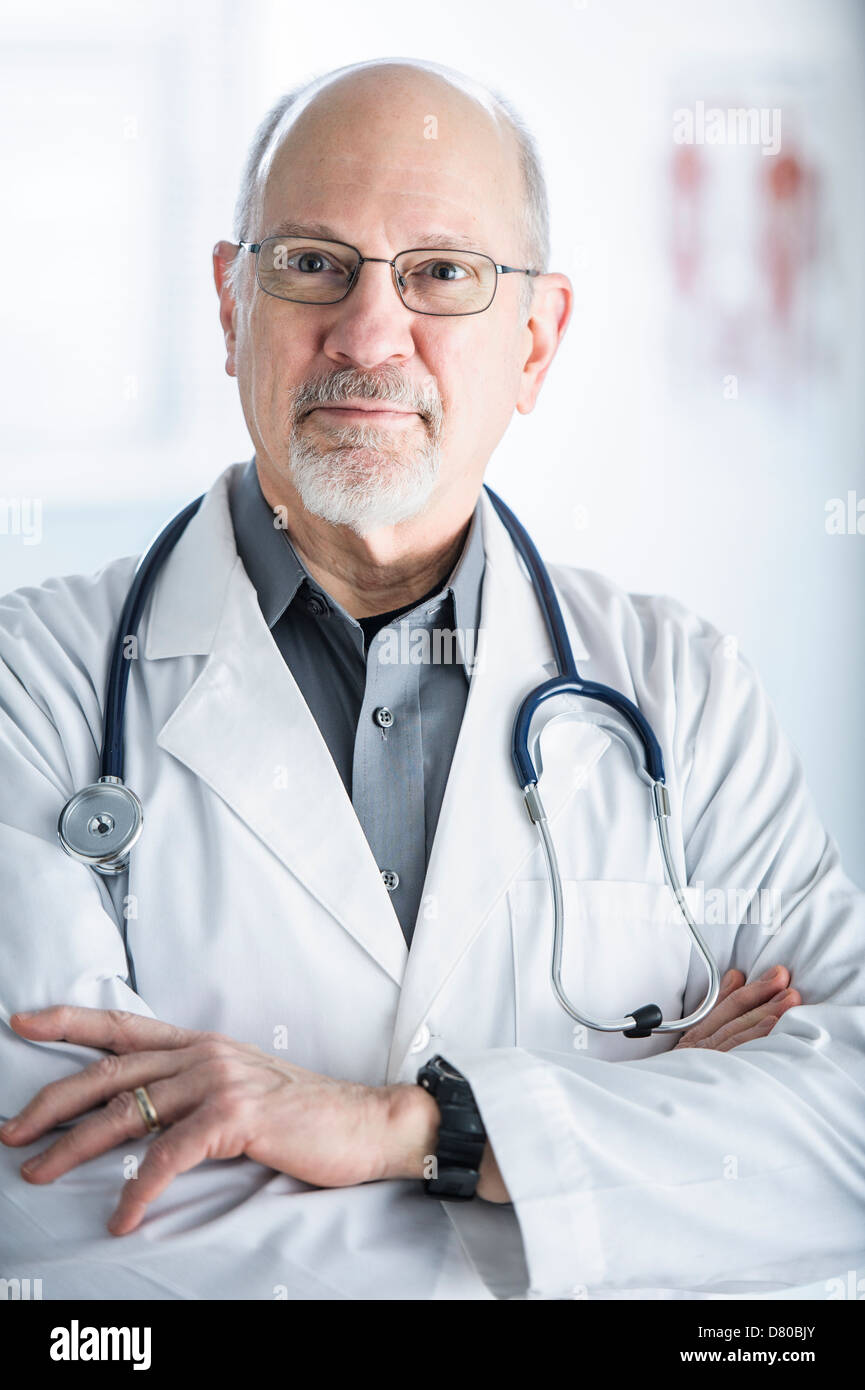 Caucasian doctor smiling in office Stock Photo - Alamy