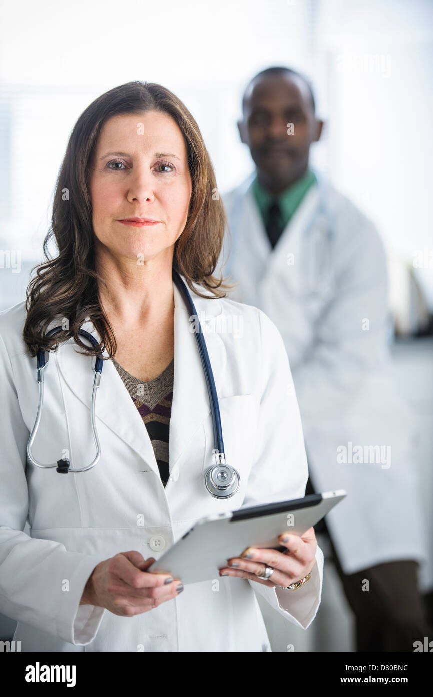 Doctors standing in office Stock Photo - Alamy