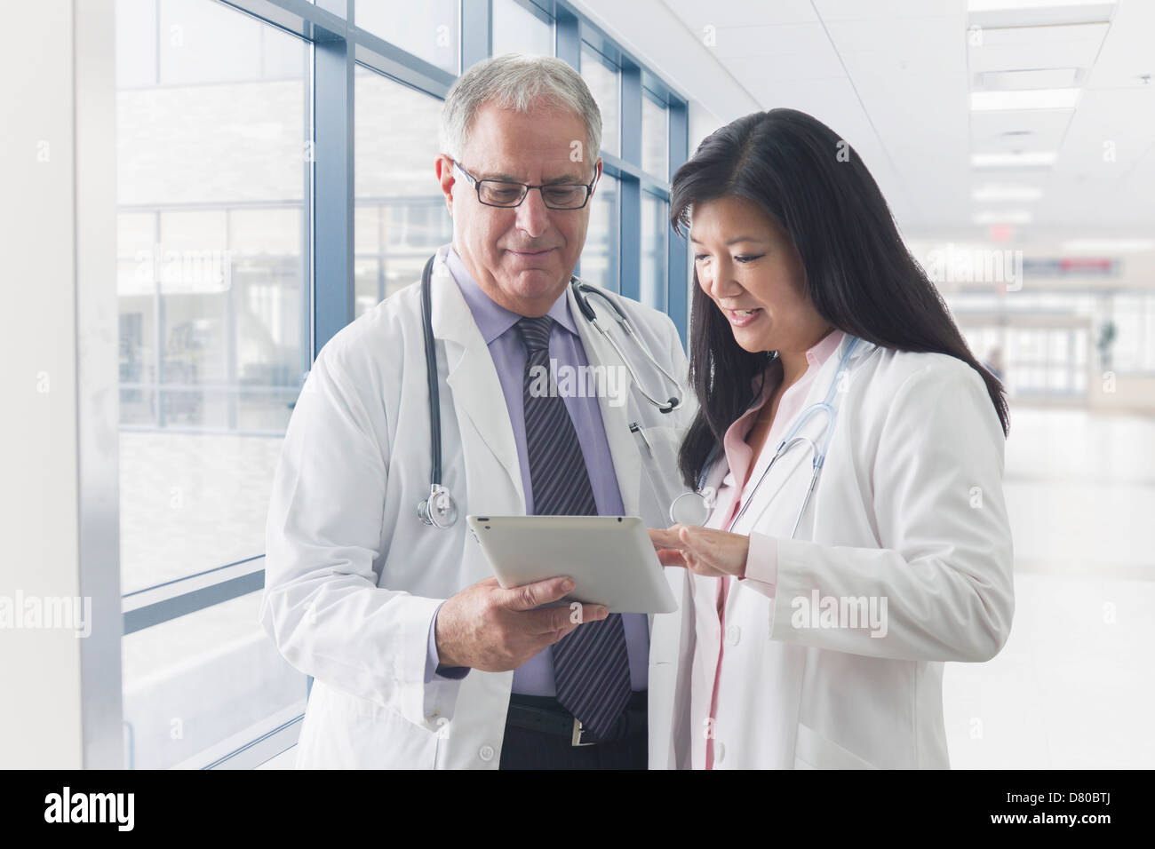 Doctors using tablet computer in hospital Stock Photo - Alamy