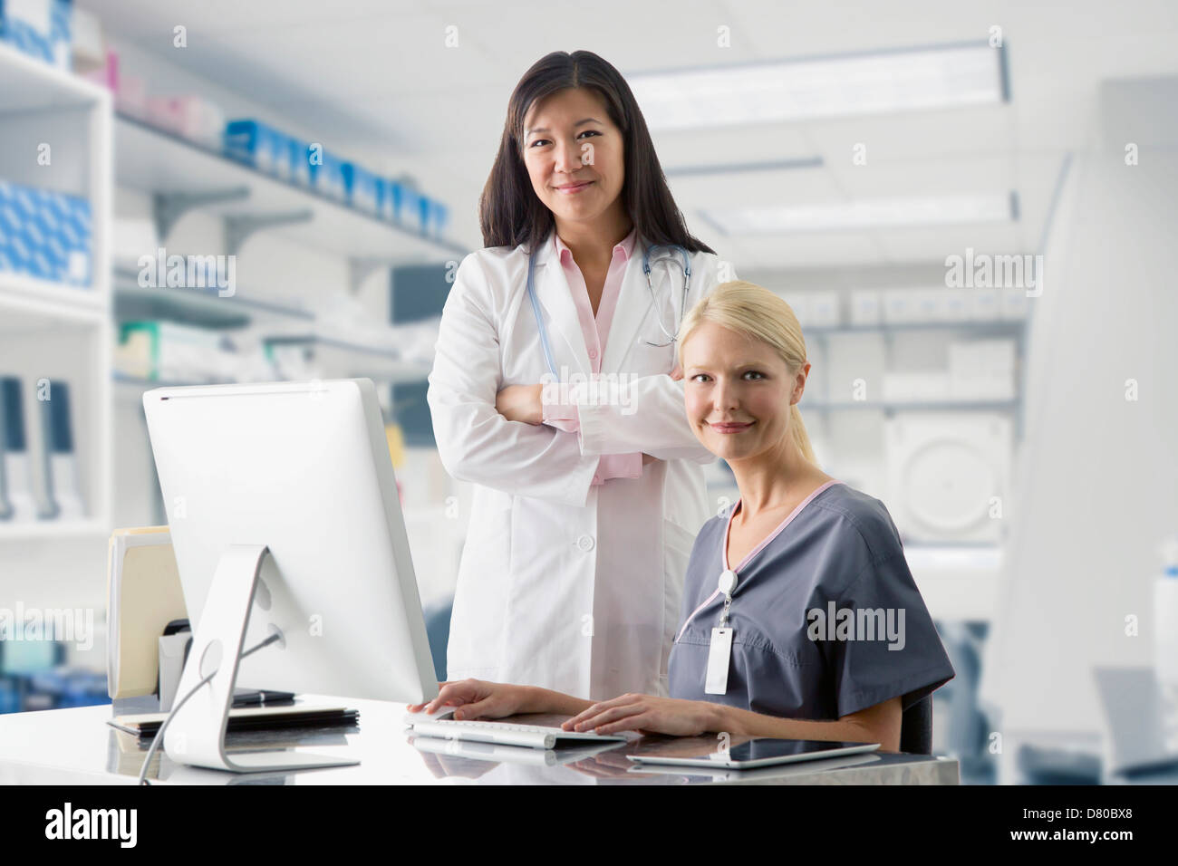 Doctor and nurse smiling at computer in hospital Stock Photo - Alamy
