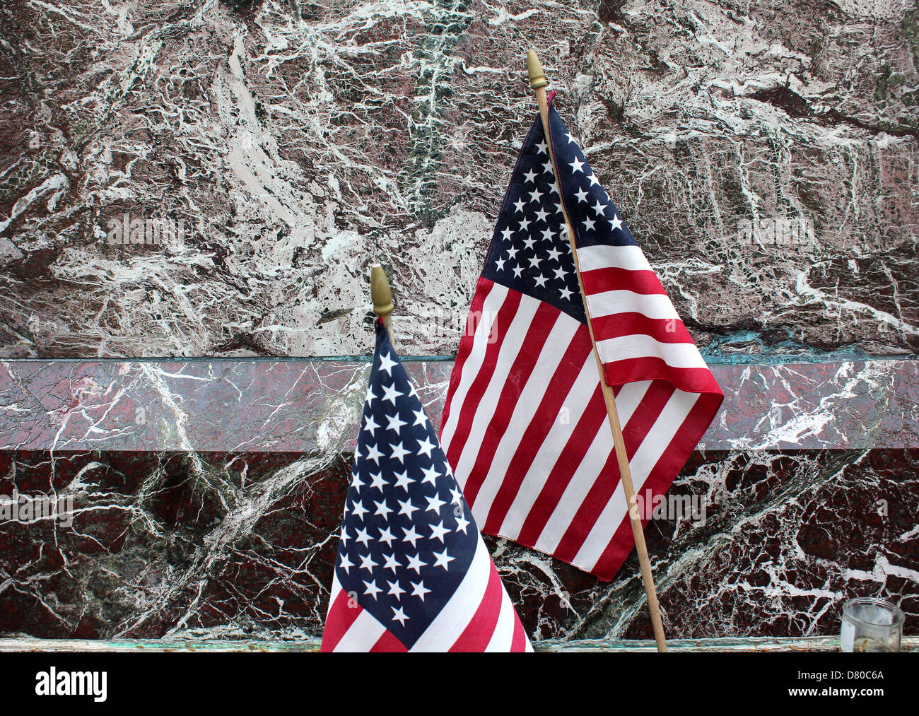 Small American flags placed at marble headstone in cemetery in honor of ...