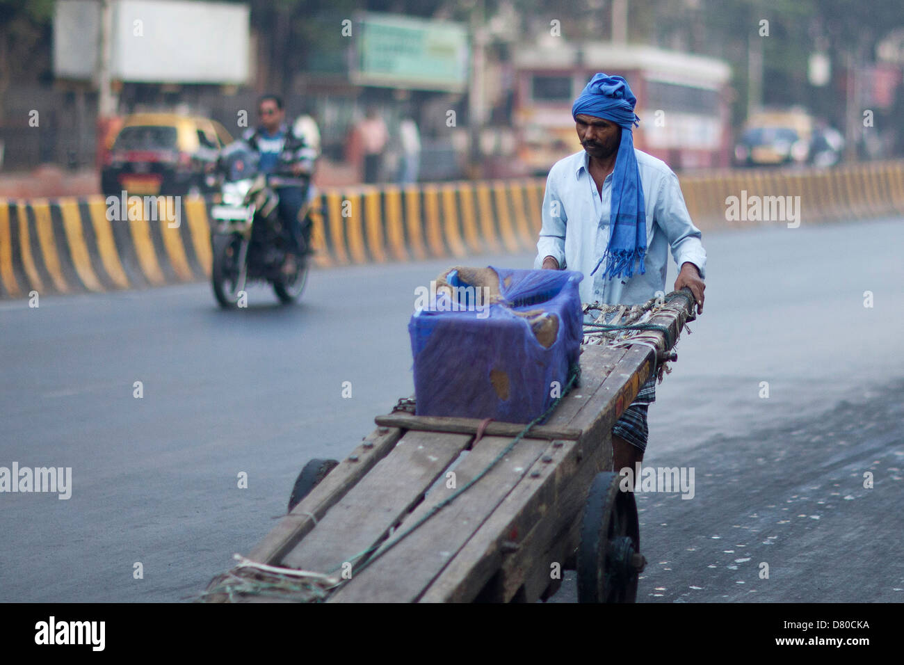 Portrait of an Indian man pushing a cart Stock Photo - Alamy