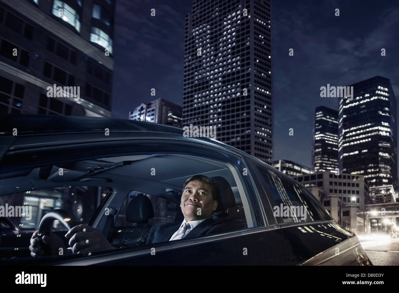 Pacific Islander businessman driving on city street Stock Photo - Alamy