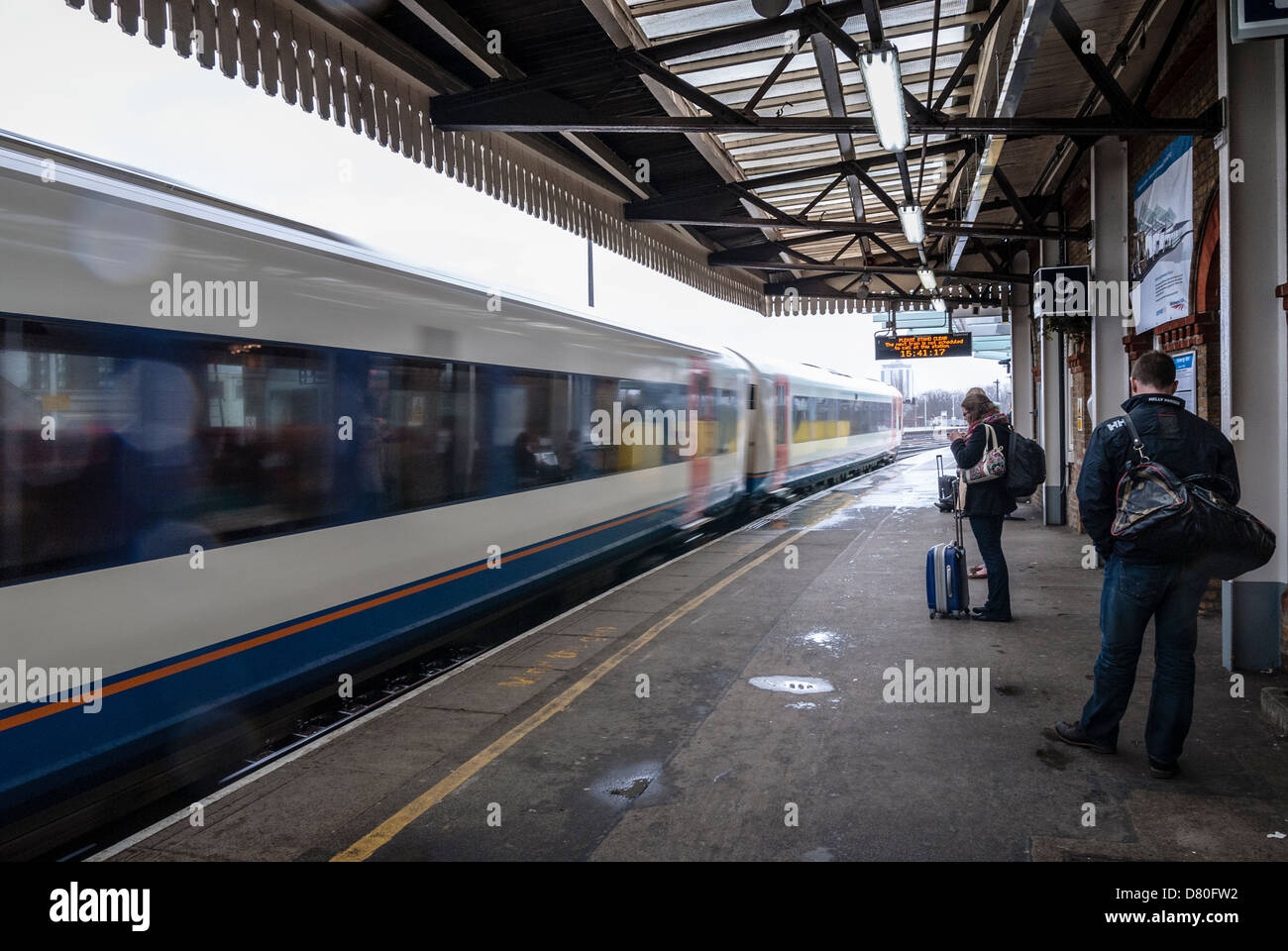 Passengers standing back from non stopping train at Clapham Junction ...