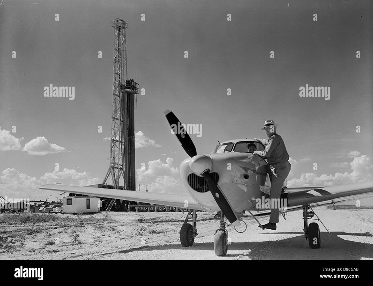 A vintage photograph of a Navion aircraft near a jackknife rig in ...