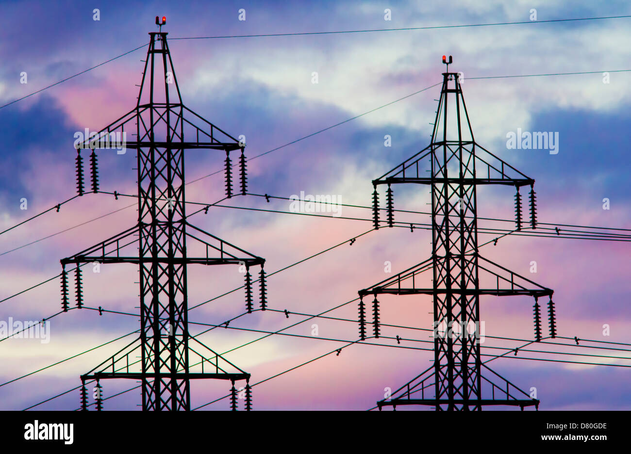 Electricity pylons in the sunset Stock Photo - Alamy