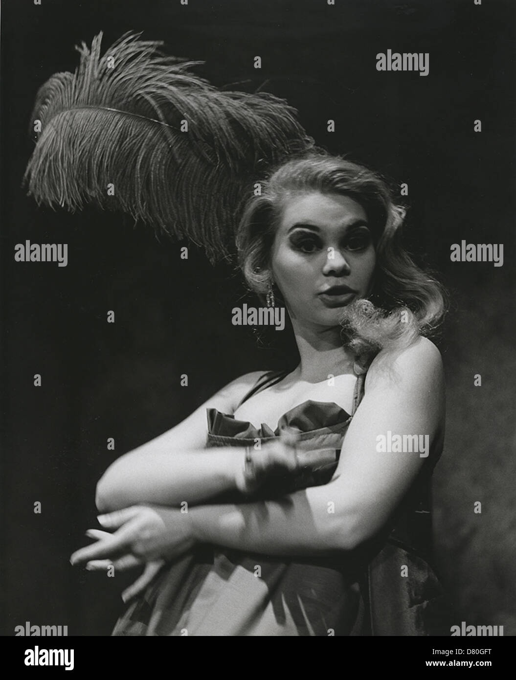 This photograph features a dramatic portrayal of a lady in costume ...