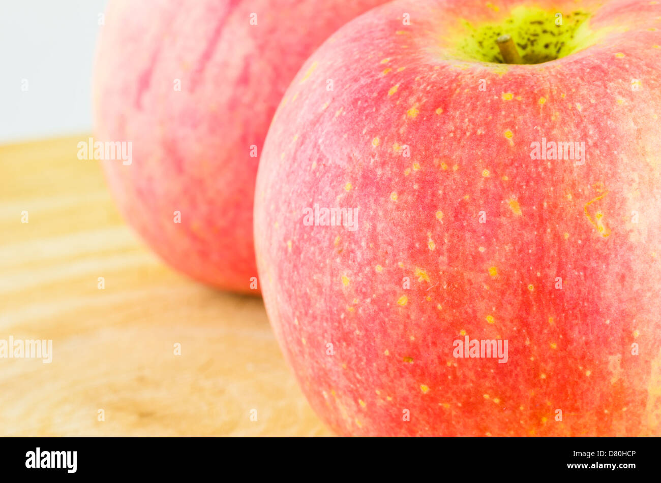 Red Apple on the wood block on white background Stock Photo - Alamy