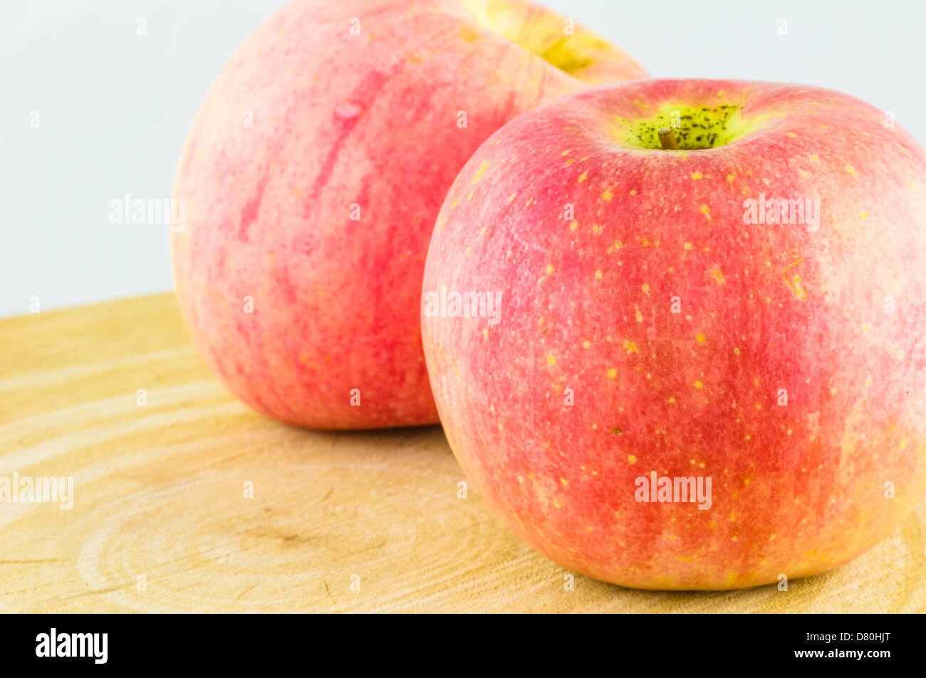 Red Apple on the wood block on white background Stock Photo - Alamy