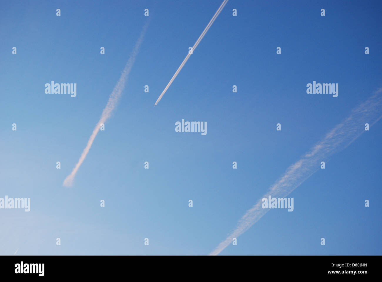 A photograph of the sky with three freshly made plane tracks Stock ...