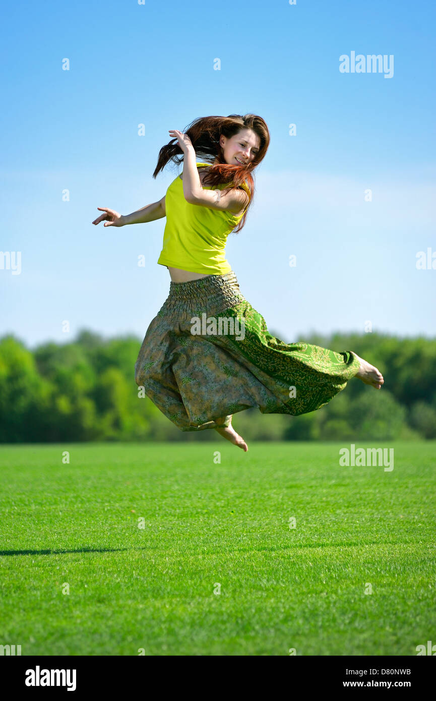 Happy sporty woman jumping hi-res stock photography and images - Alamy