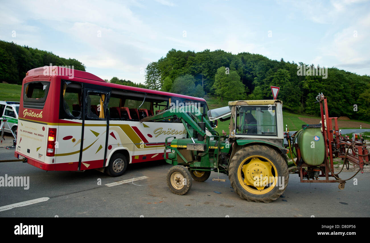 A school bus is parked after a collision with a tractor near ...